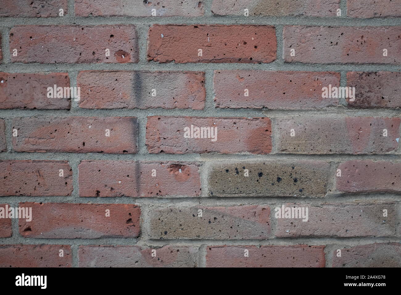 Head-on view of a modern, red brick wall with worn damage Stock Photo ...