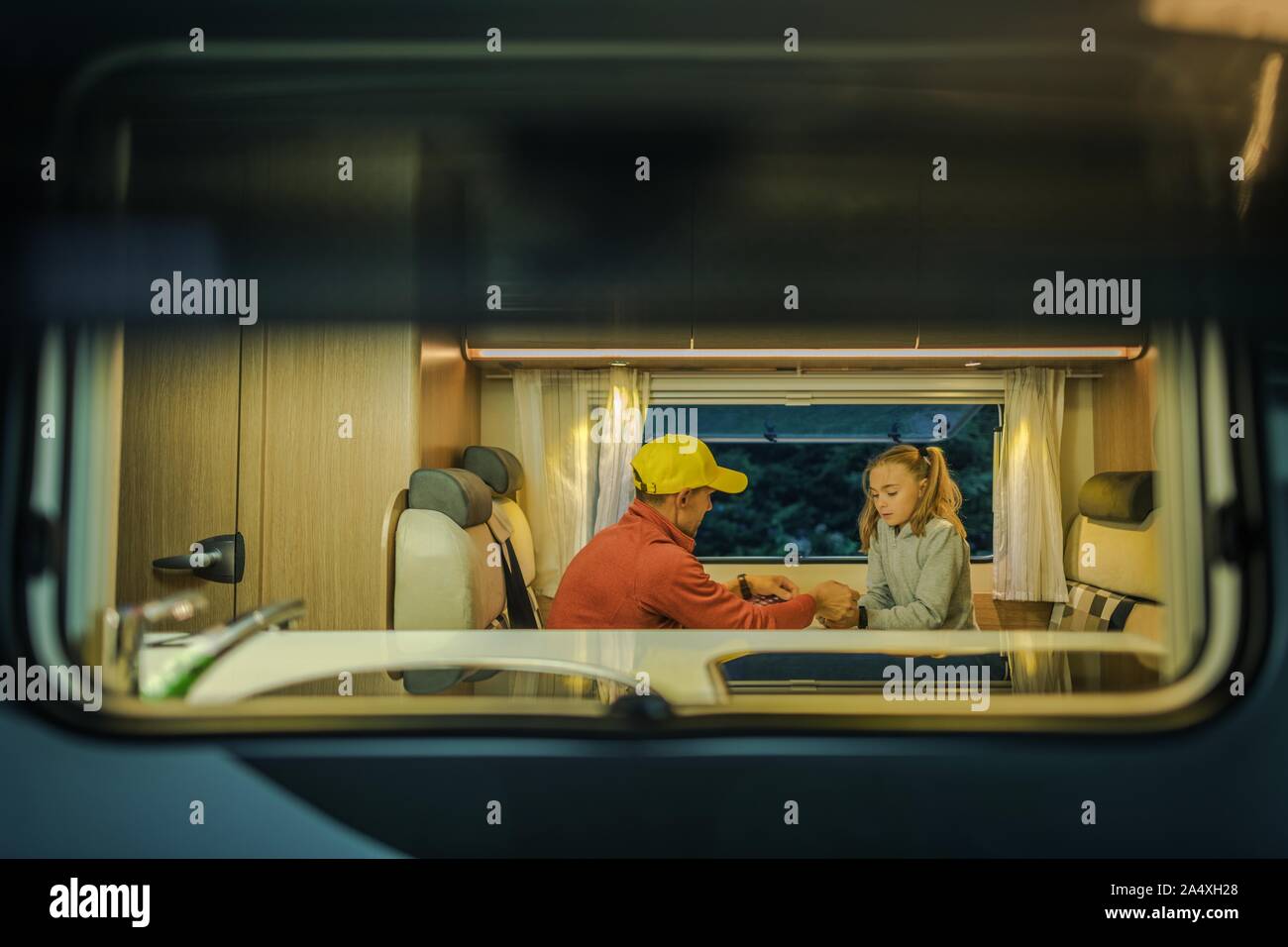 Family RV Camper Trip. Caucasian Father and Daughter Playing Inside ...