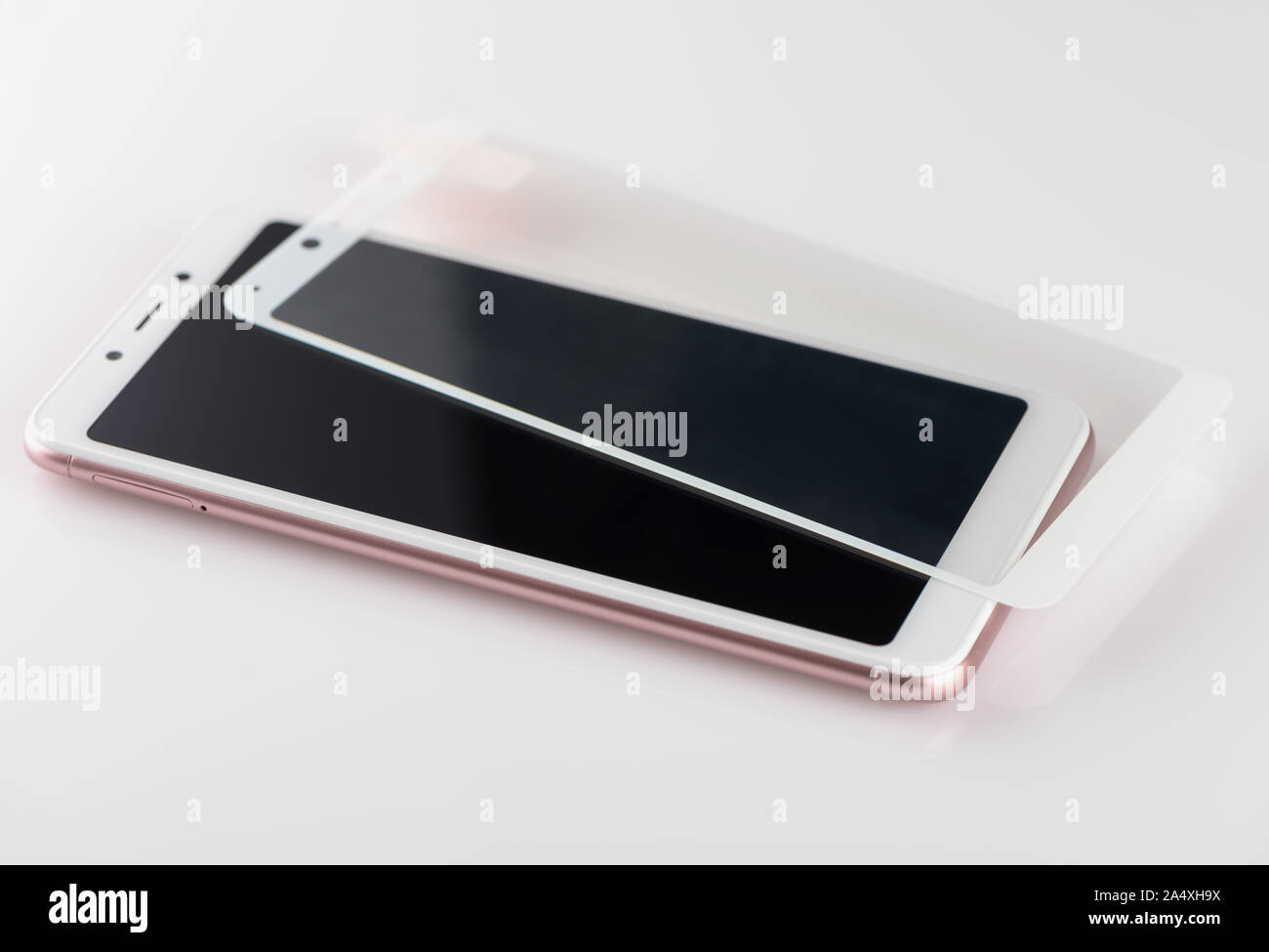 White smartphone and protective glass on it on a white background Stock ...