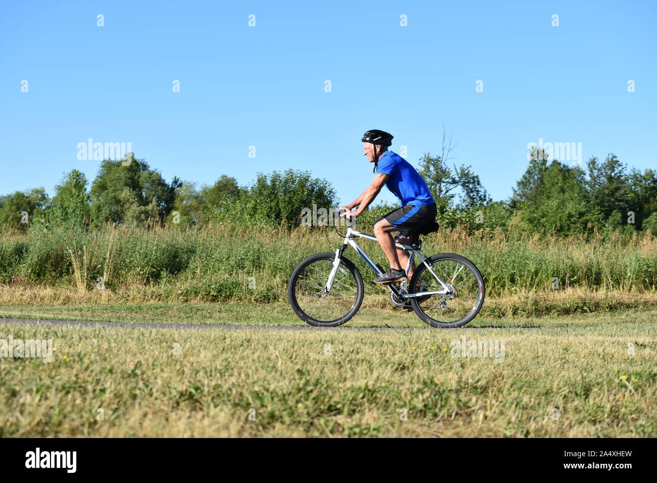 Older man riding bike hi-res stock photography and images - Alamy
