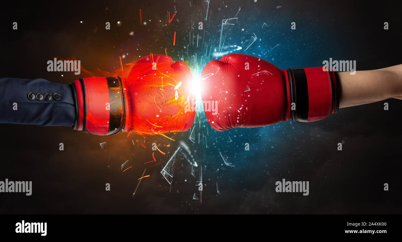 Two hands fighting and breaking glass into small pieces with fire and ...