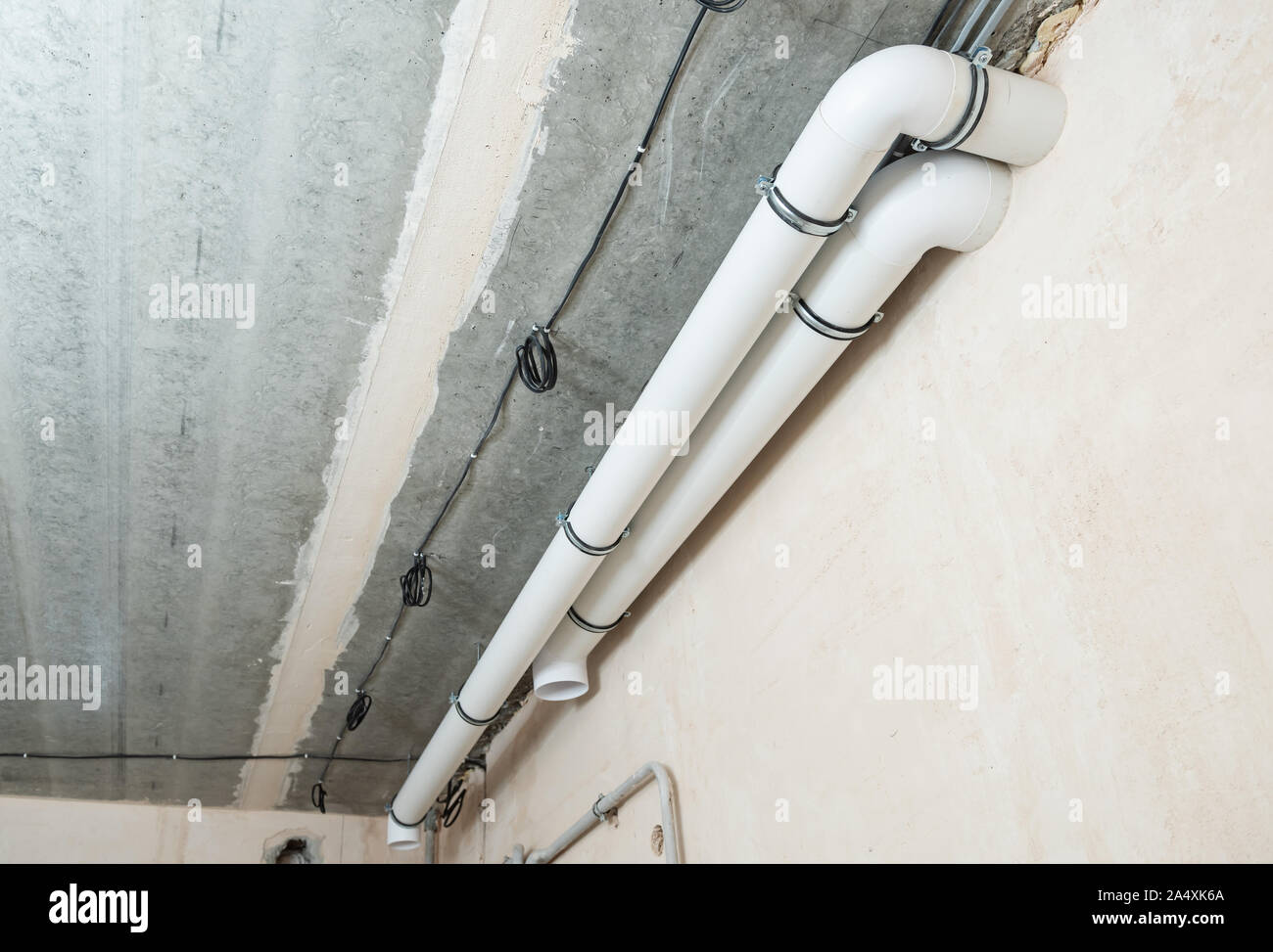 Plastic ventilation pipes are fixed to the concrete ceiling Stock Photo ...