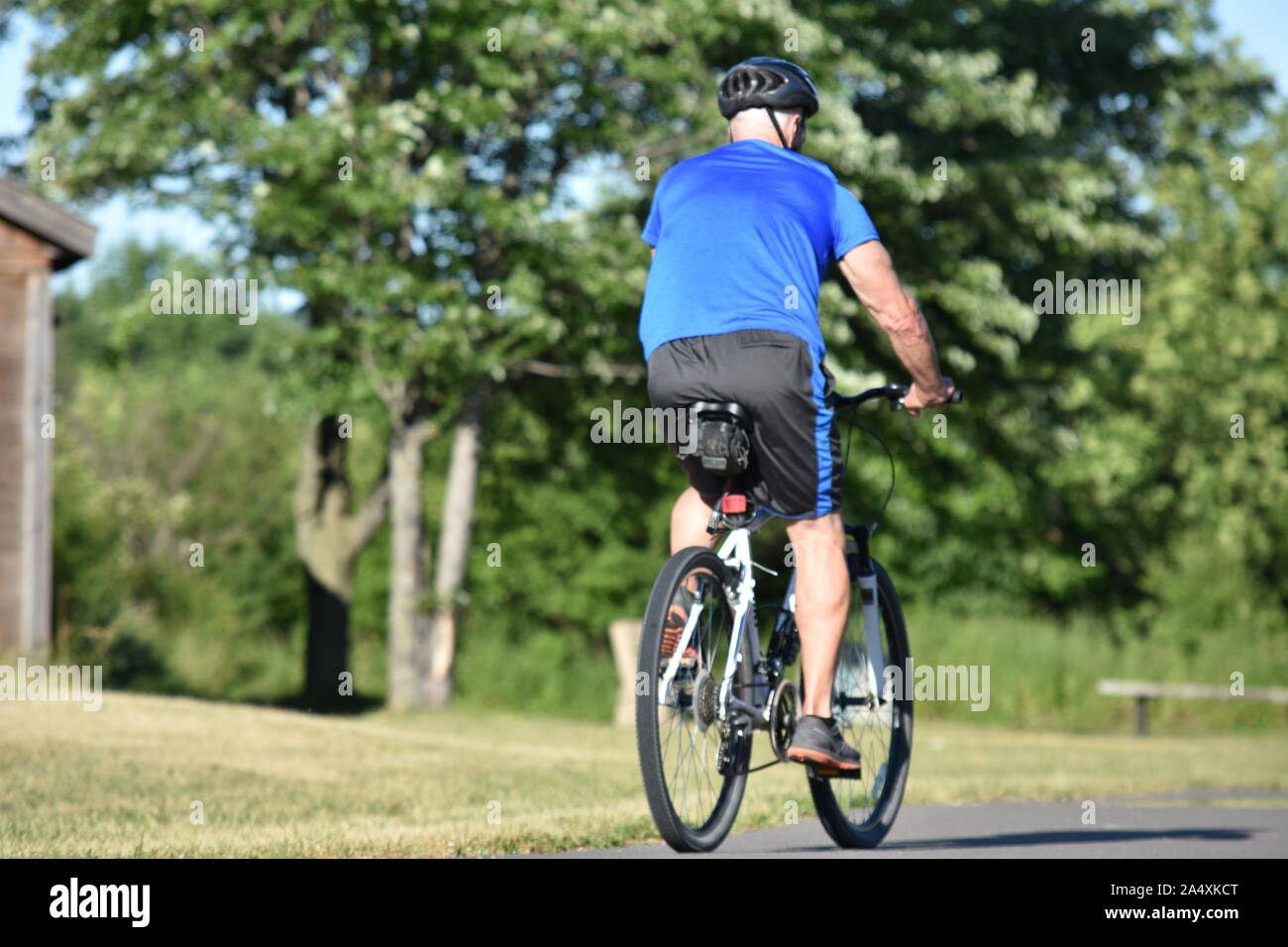 Male Cyclist Working Out Wearing Helmet Riding Bike Stock Photo - Alamy