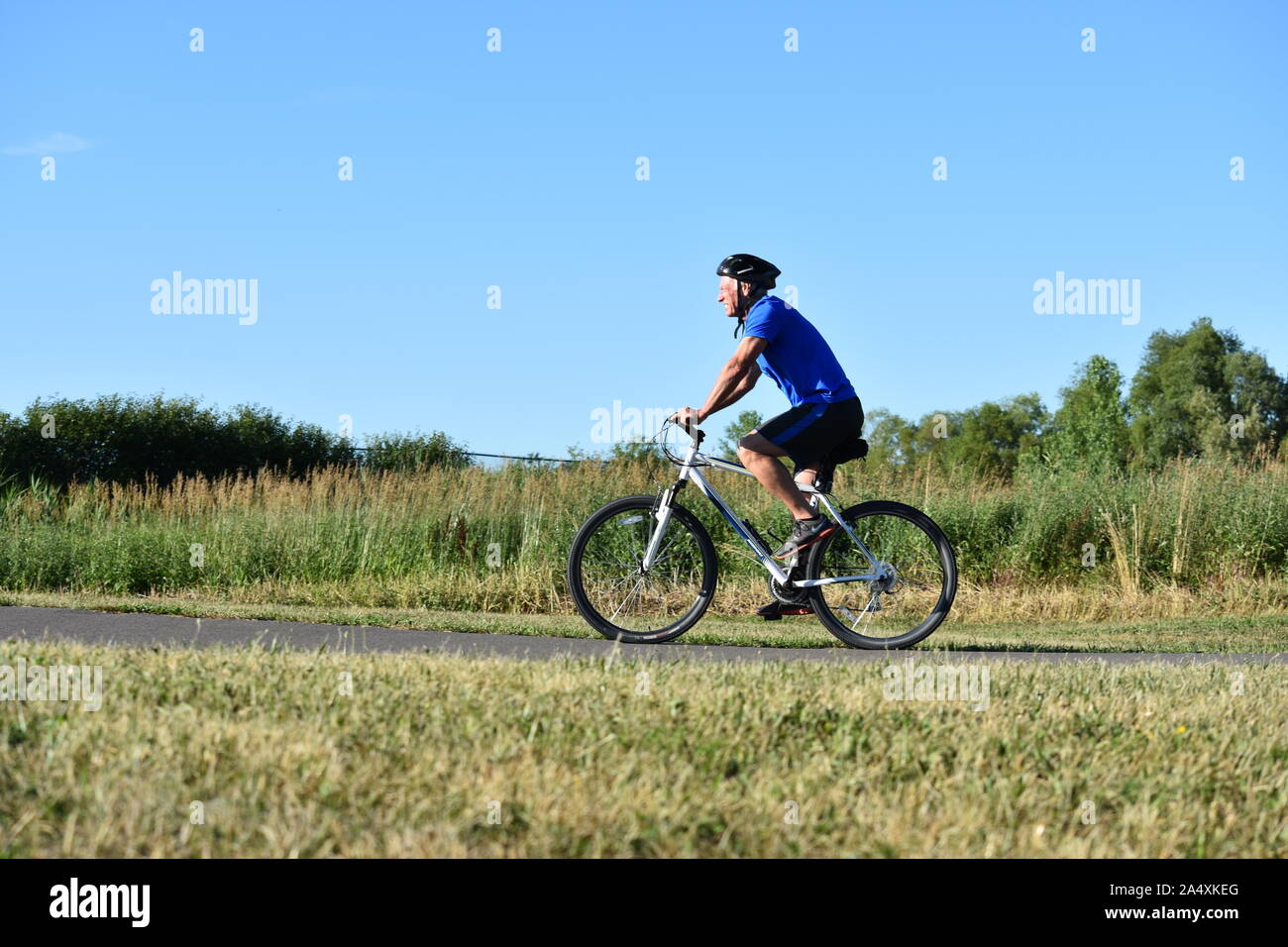 Exercising Athlete Retiree Male Cyclist Wearing Helmet Riding Bike ...