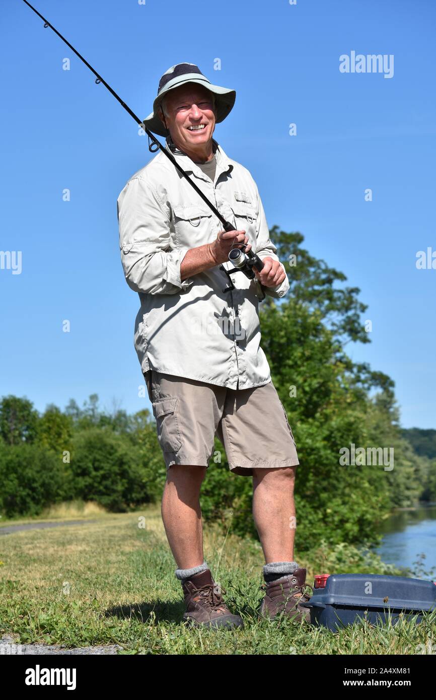 Smiling Older Male Fisherman With Fishing Rod Fishing Stock Photo - Alamy