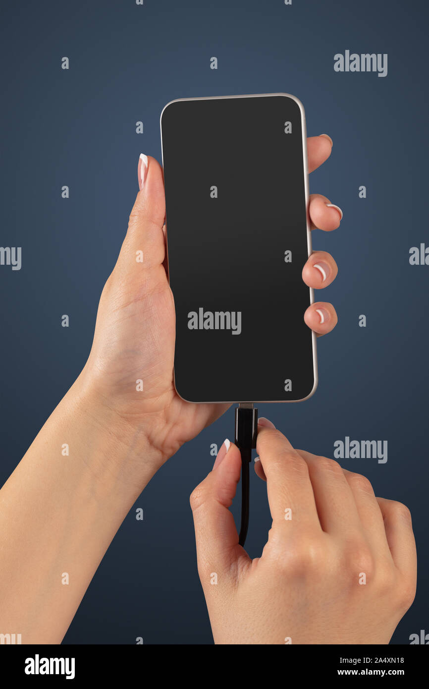 Close-up view of hand charging smartphone Stock Photo - Alamy