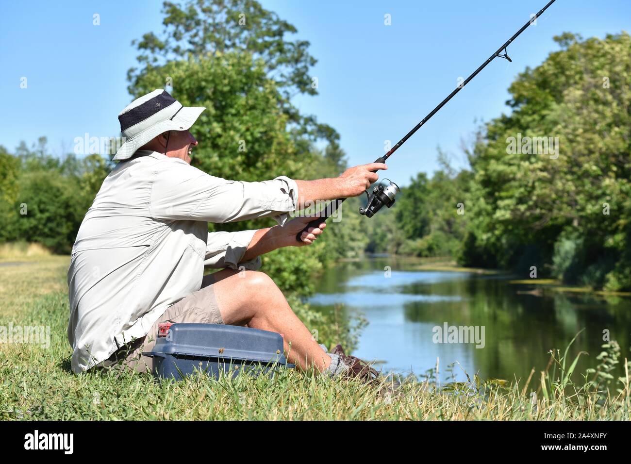 Old Retiree Male Fisherman Sitting With Fishing Rod Fishing Stock Photo ...