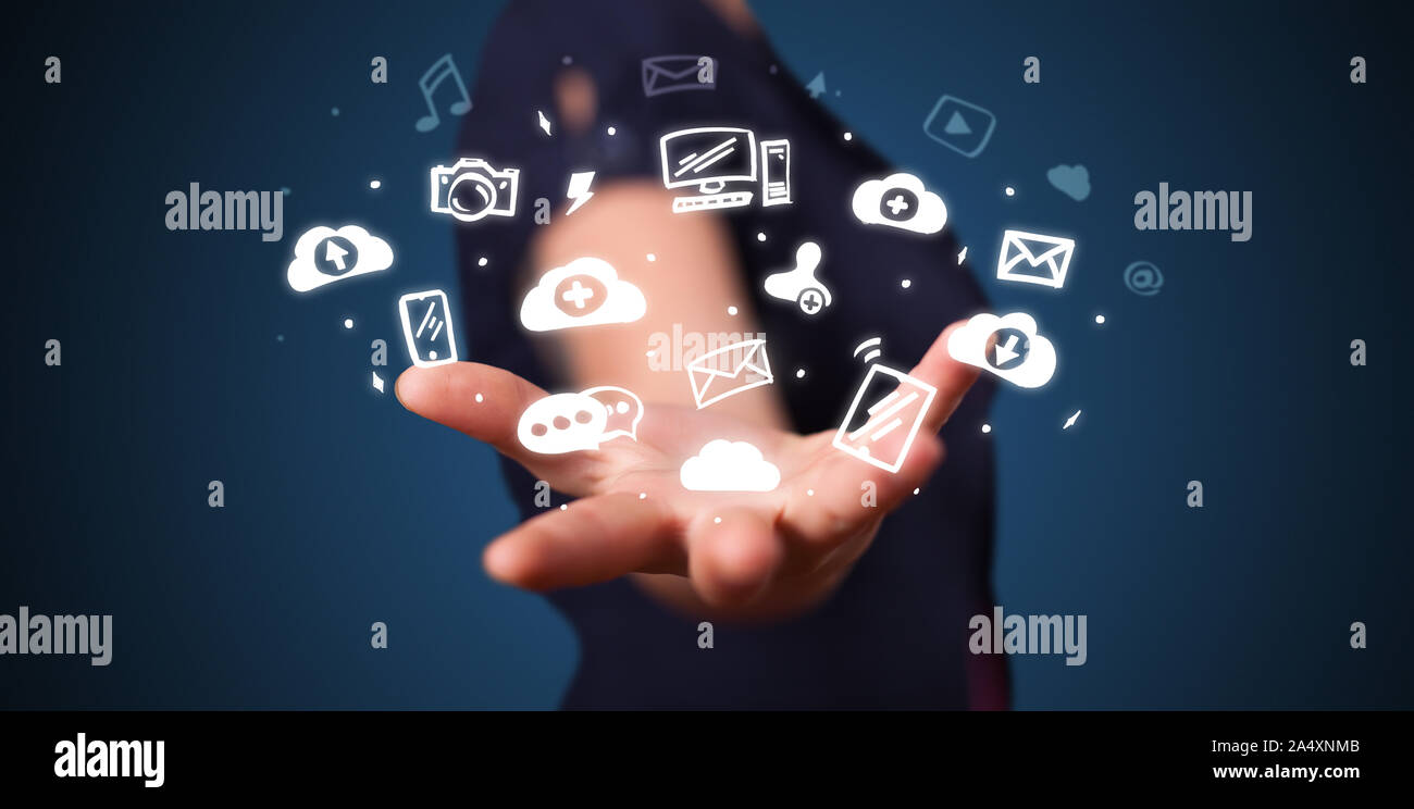 Hand holding application icons and symbols in her hand Stock Photo - Alamy