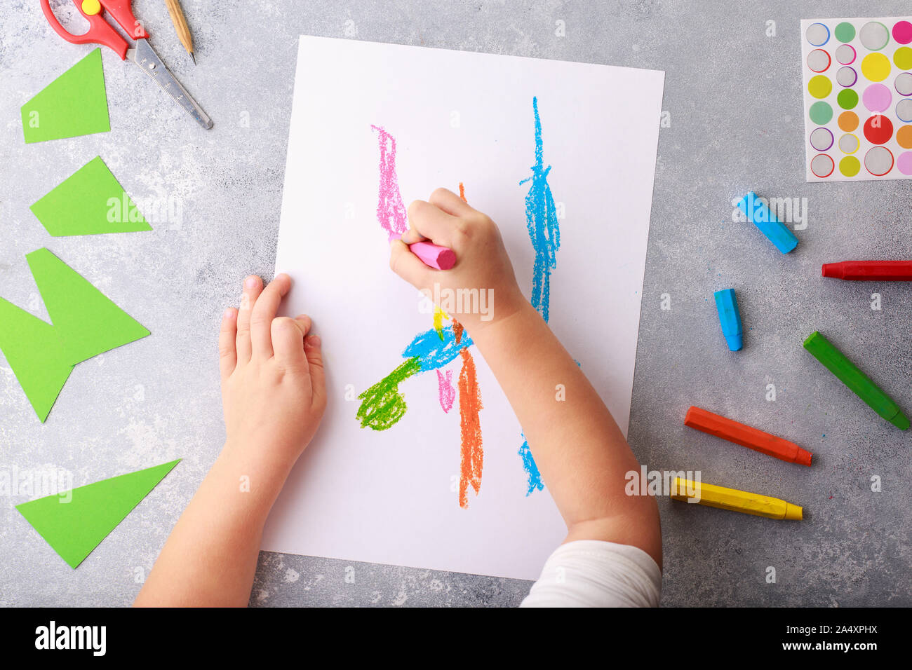 Child draws a pencil drawing empty space colorful grey background top ...
