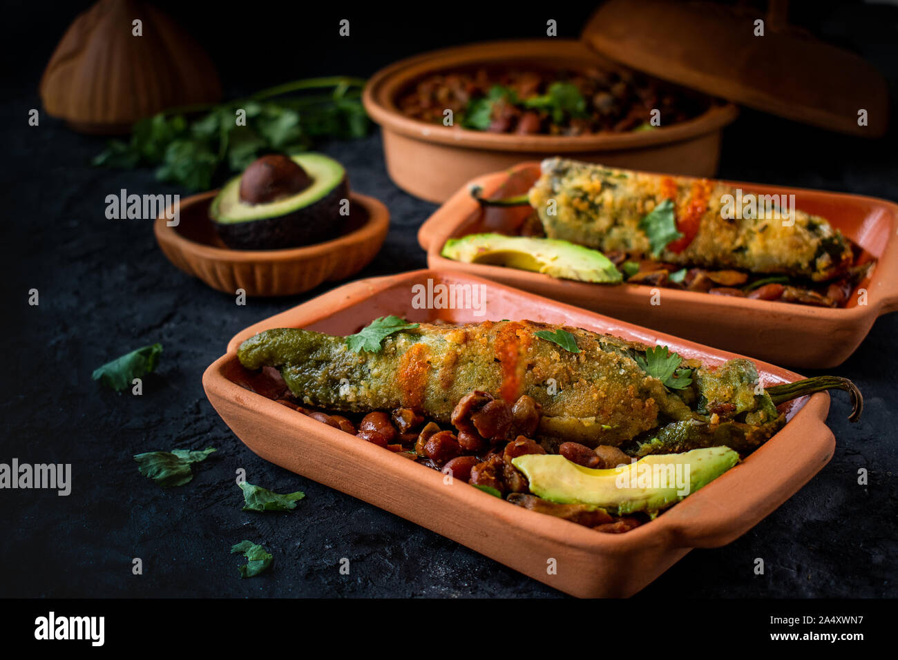 Chile Rellenos Served in Traditional Mexican Clay Plates Stock Photo ...