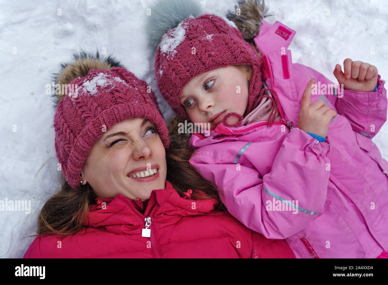 Fashionable stylish family having fun playing in snow. Weekends ...