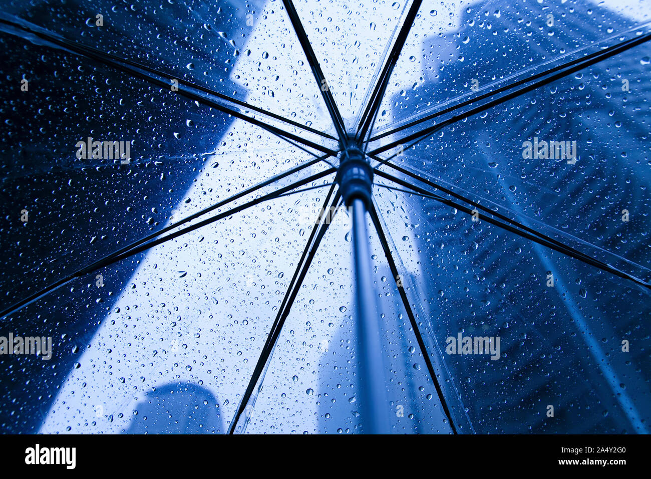 A rainy city building seen from a plastic umbrella Stock Photo - Alamy