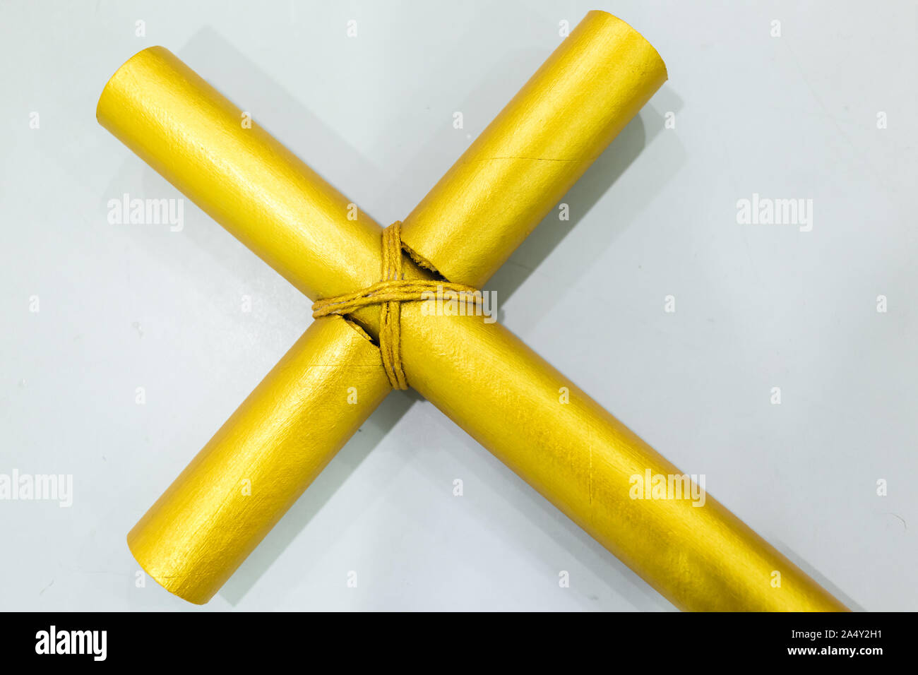 golden color cross on white background closeup Stock Photo - Alamy