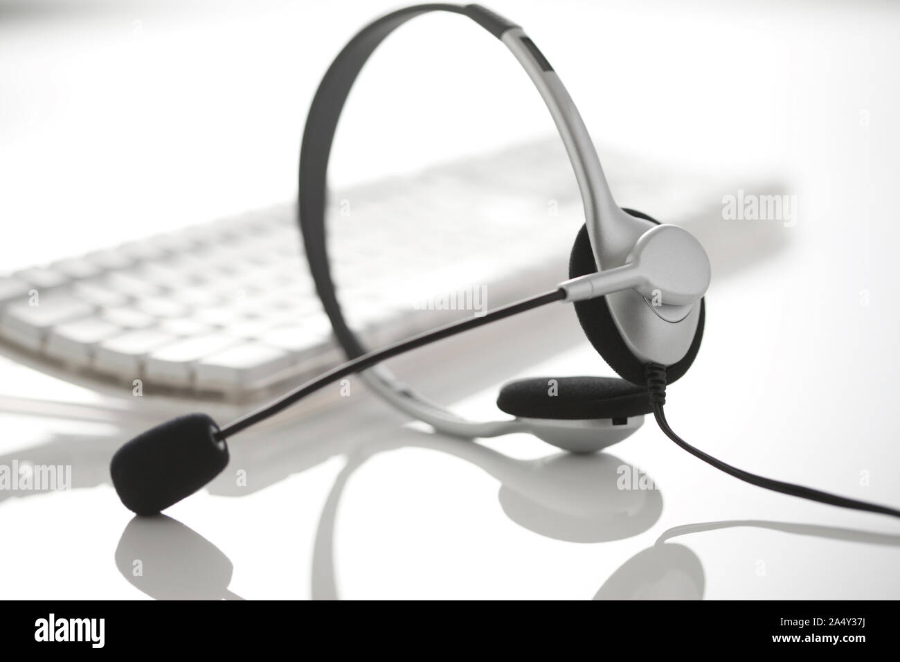 Office desk with headset and PC Stock Photo - Alamy