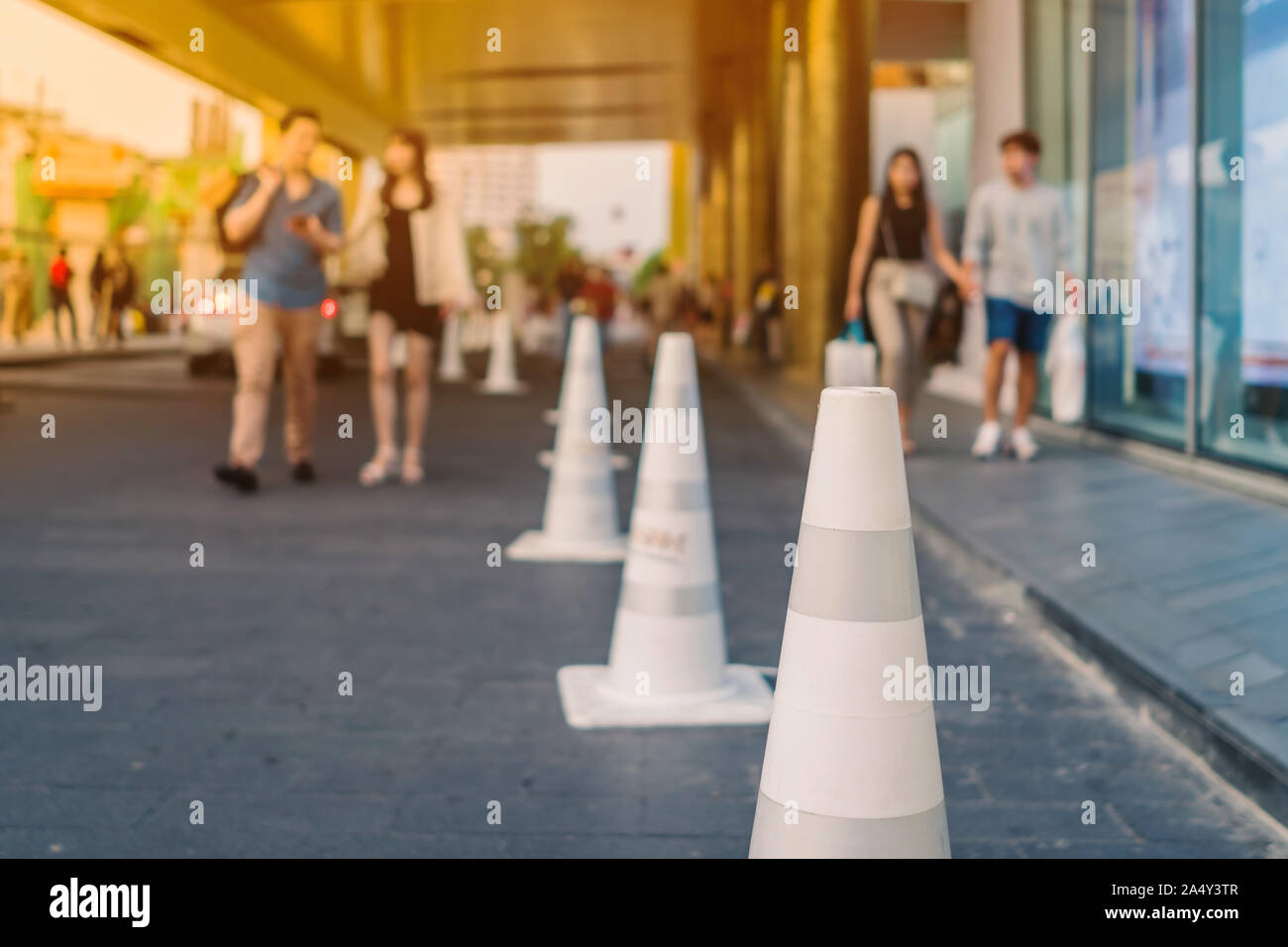 The white traffic cones are set up as a pedestrian safety zone in front ...