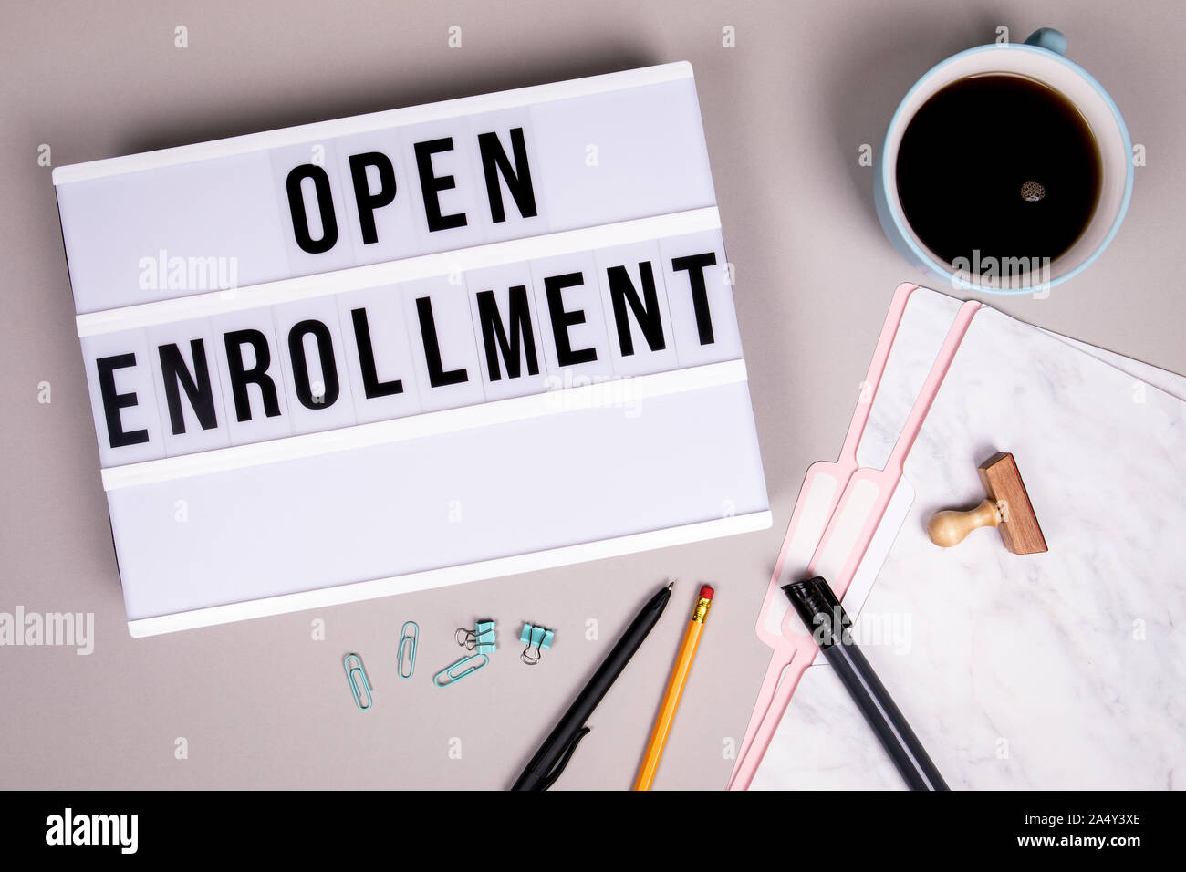 Open Enrollment concept. White lightbox on a grey office desk Stock ...
