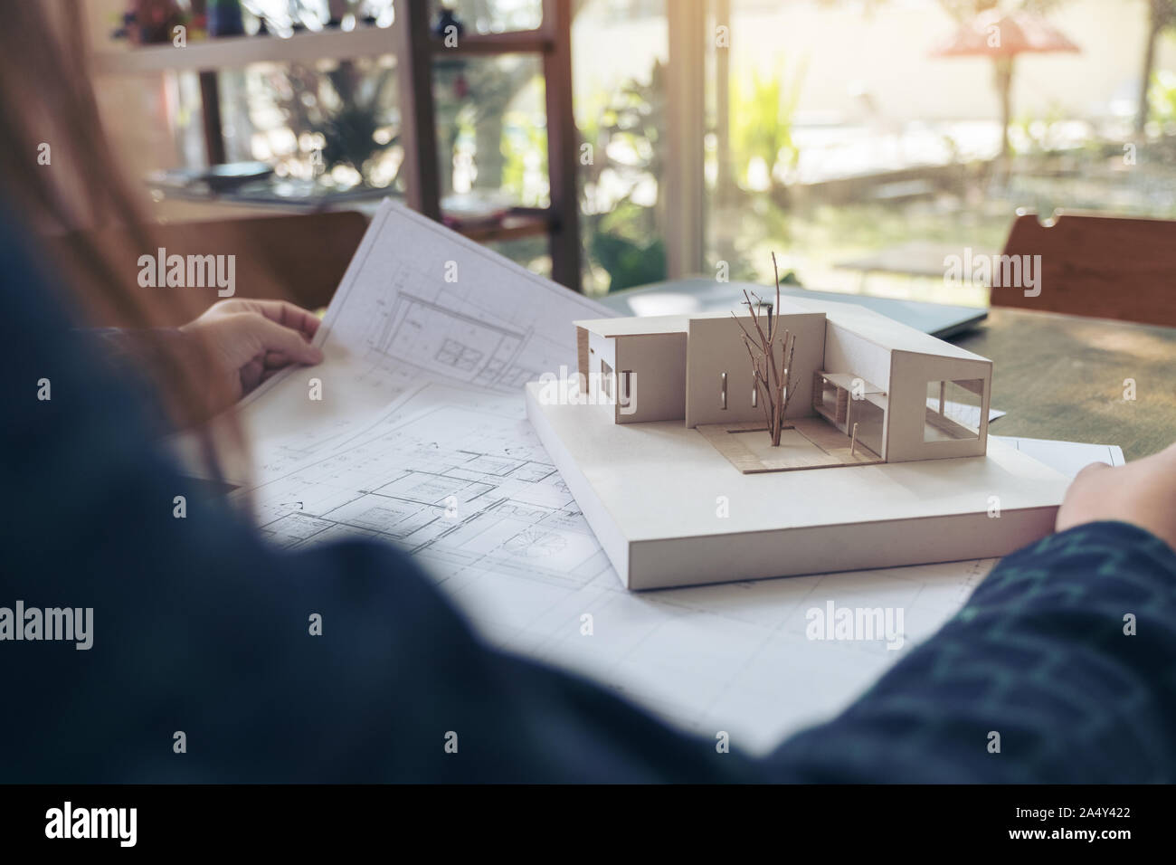 An architect working and looking at an architecture model with shop ...