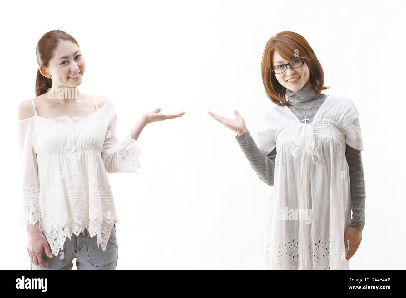 Two women posing for guidance Stock Photo - Alamy