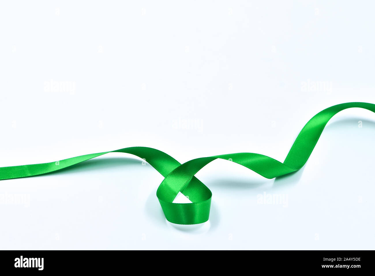 Green curly ribbon on white background, decorative elements Stock Photo ...