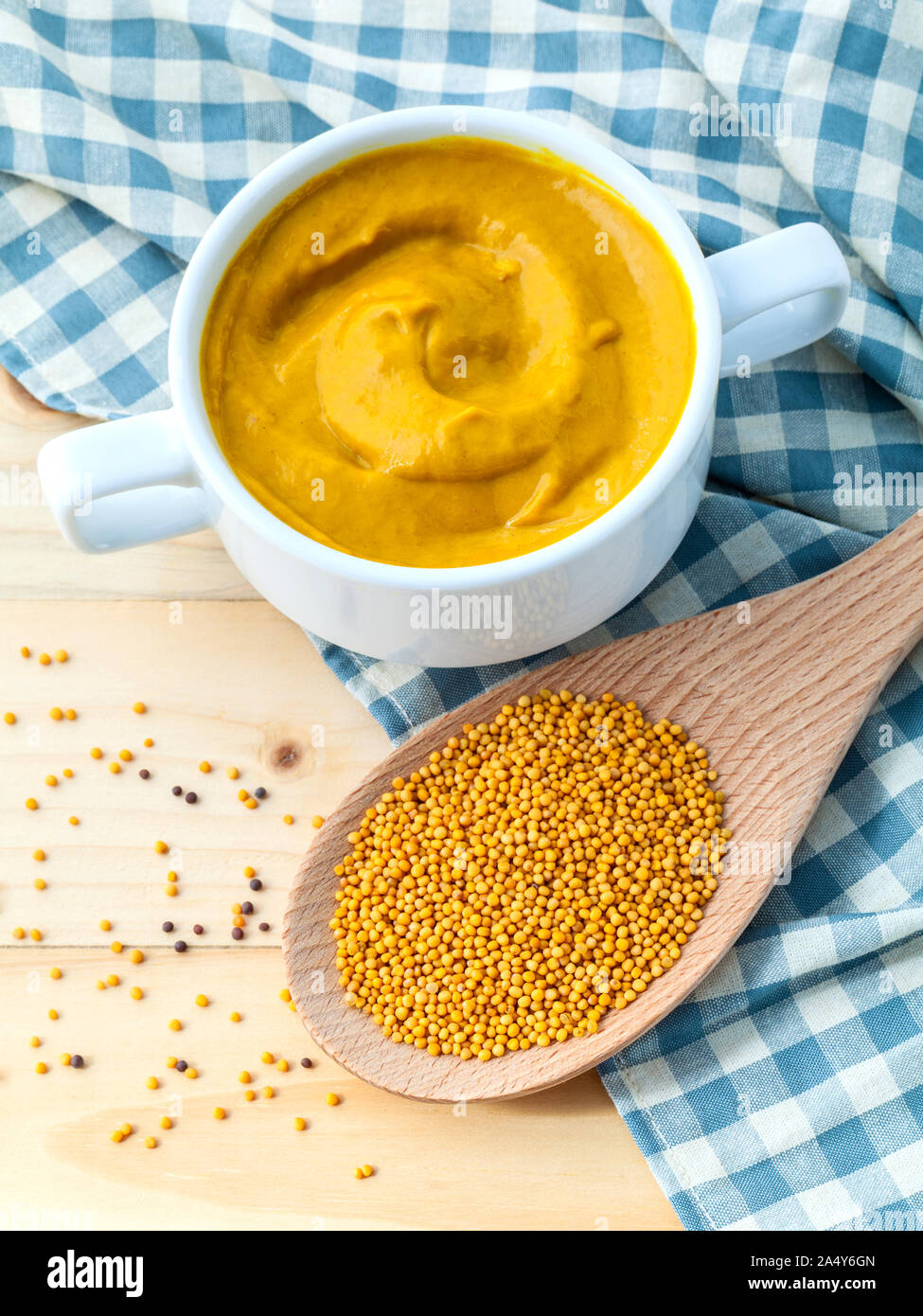 Composition of mustard and mustard seeds on wooden background Stock ...