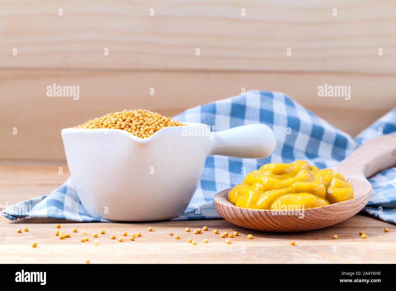 Composition of mustard and mustard seeds on wooden background Stock ...