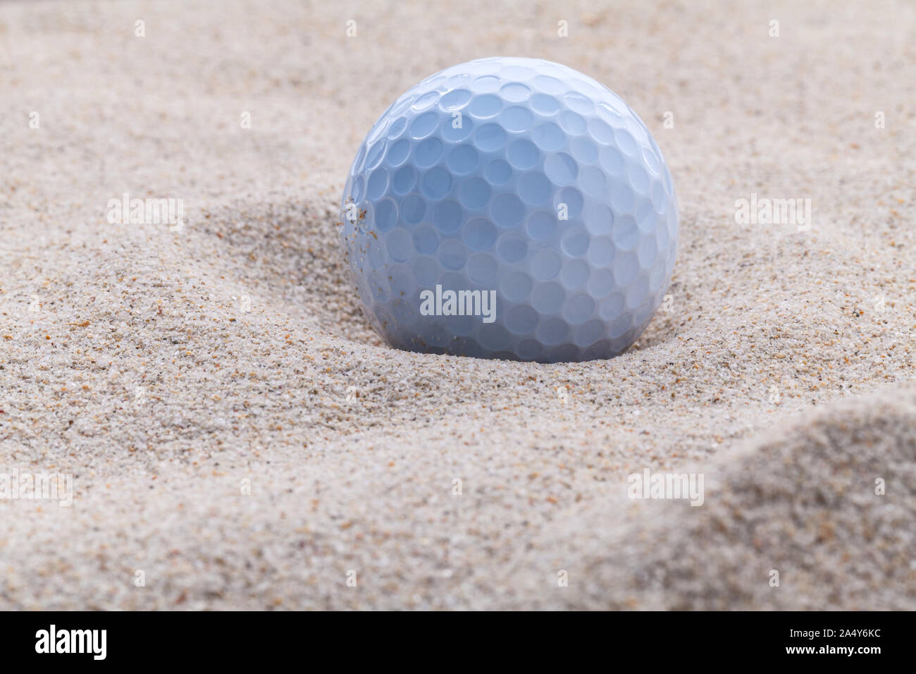 Close up golf ball in sand bunker shallow depth of field Stock Photo ...