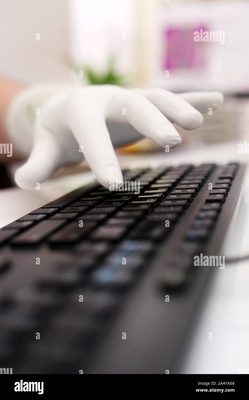Picture of man typing with keyboard and wearing hand gloves. Isolated ...