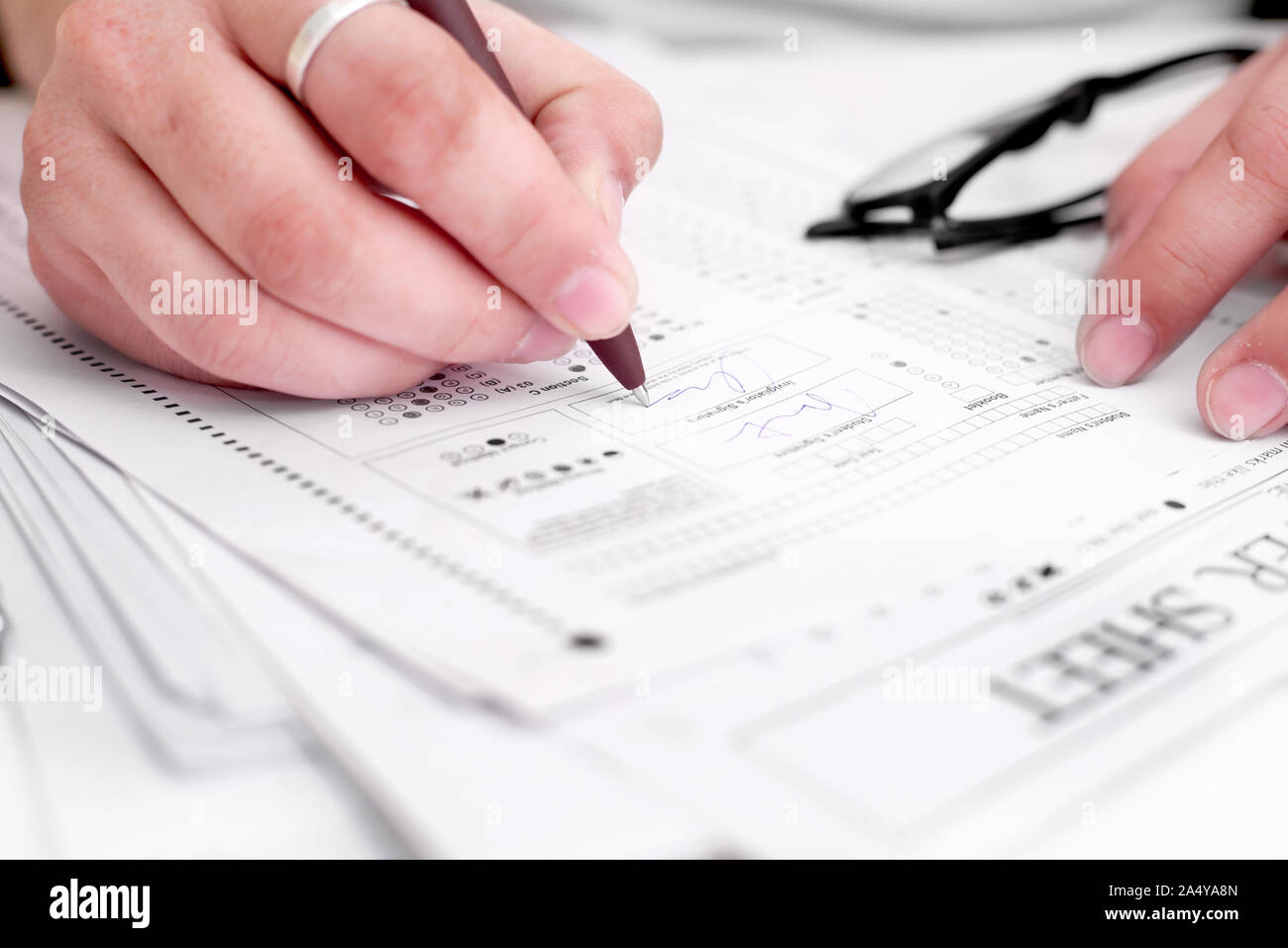 Picture of a man filling the OMR sheet Stock Photo - Alamy