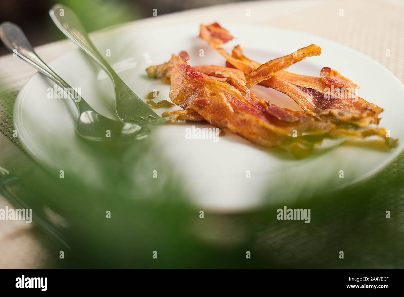 crispy fried bacon on white dish with selective focus point Stock Photo ...