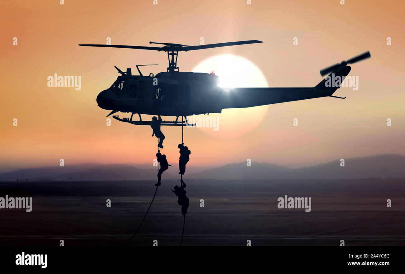 Military commandos helicopter drops during sunrise Stock Photo - Alamy