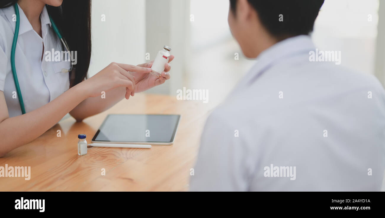 Close-up view of young female doctor explaining medical description to ...