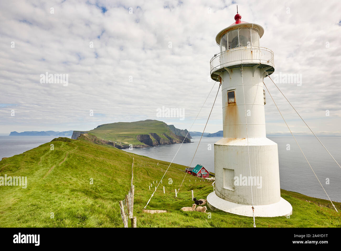 Mykines lighthouse and cliffs on Faroe islands. Hiking landmark ...
