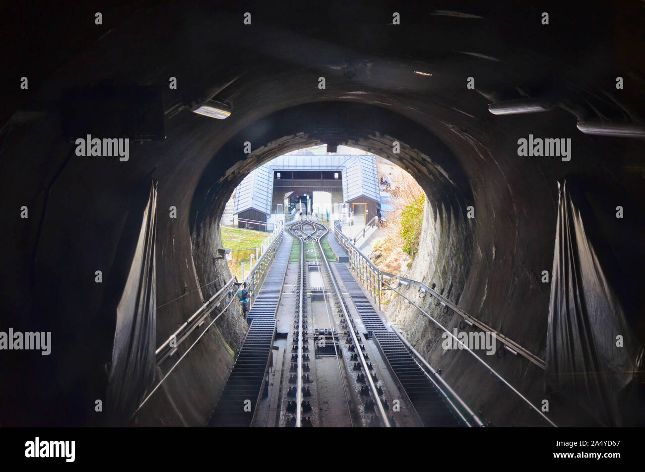 Light at the end of the tunnel concept - train exit from an underground ...