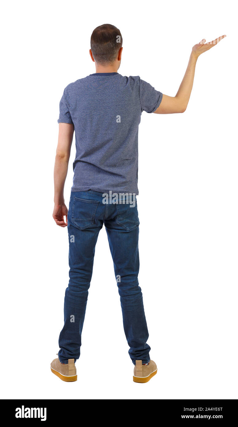 Back view of man looking at wall and Holds hand up. Rear view people ...