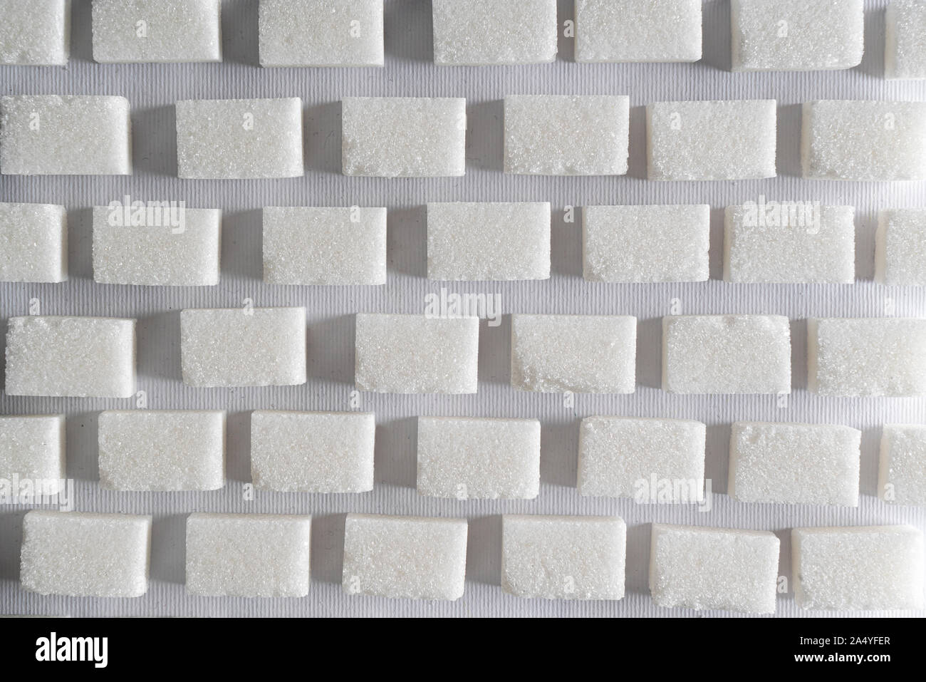 the background pattern formed with sugar cubes Stock Photo - Alamy