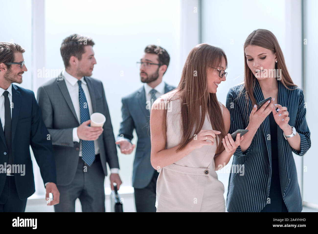 young employees exchanging information in the office lobby Stock Photo ...