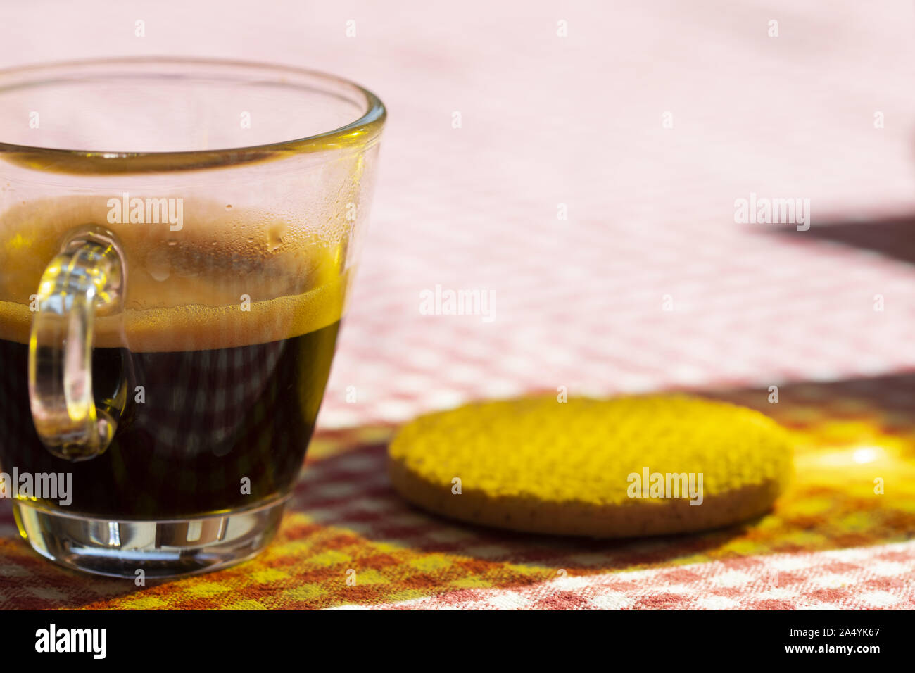 cup of espresso coffee with a biscuit in a colored light beam Stock ...