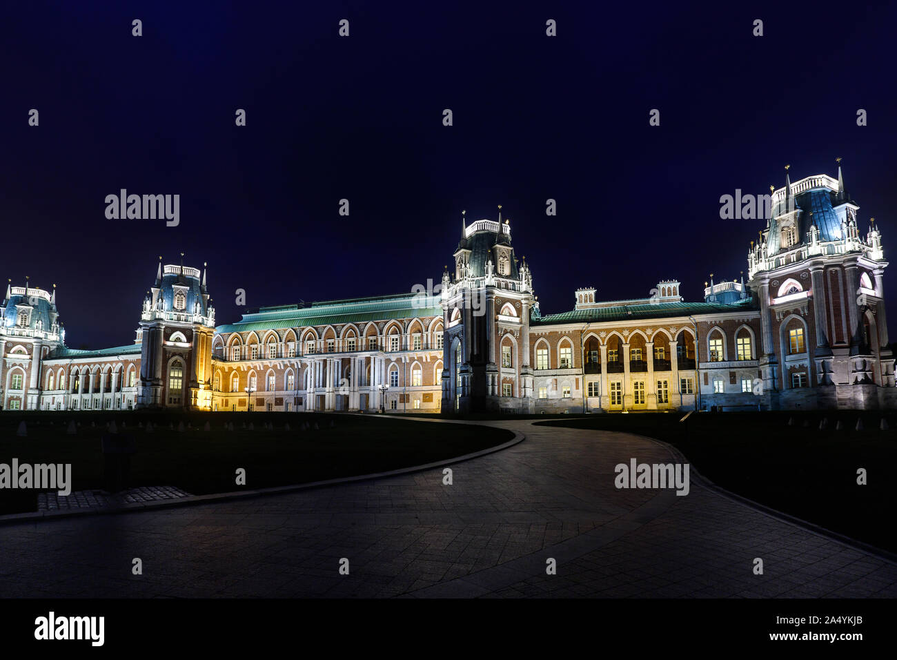 Night panorama of the magnificent old Gothic castle of red brick ...