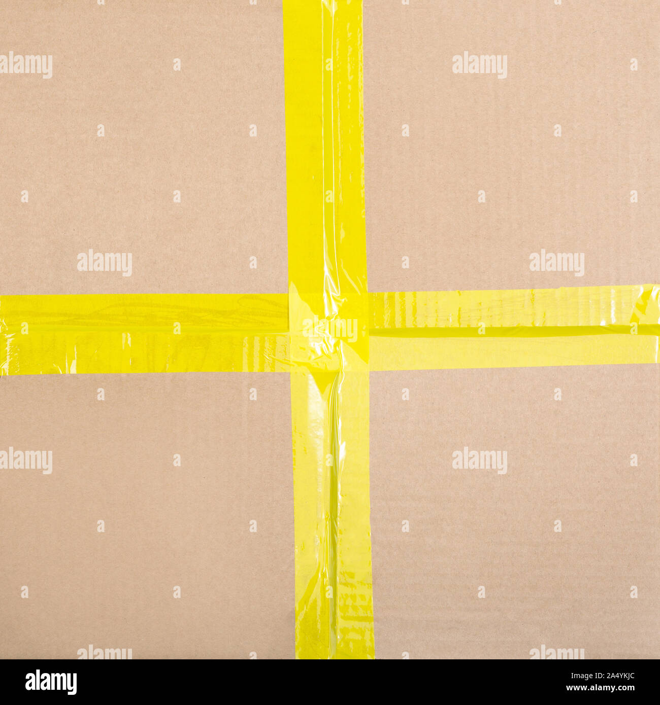 Cardboard background with a yellow sticky tape Stock Photo - Alamy