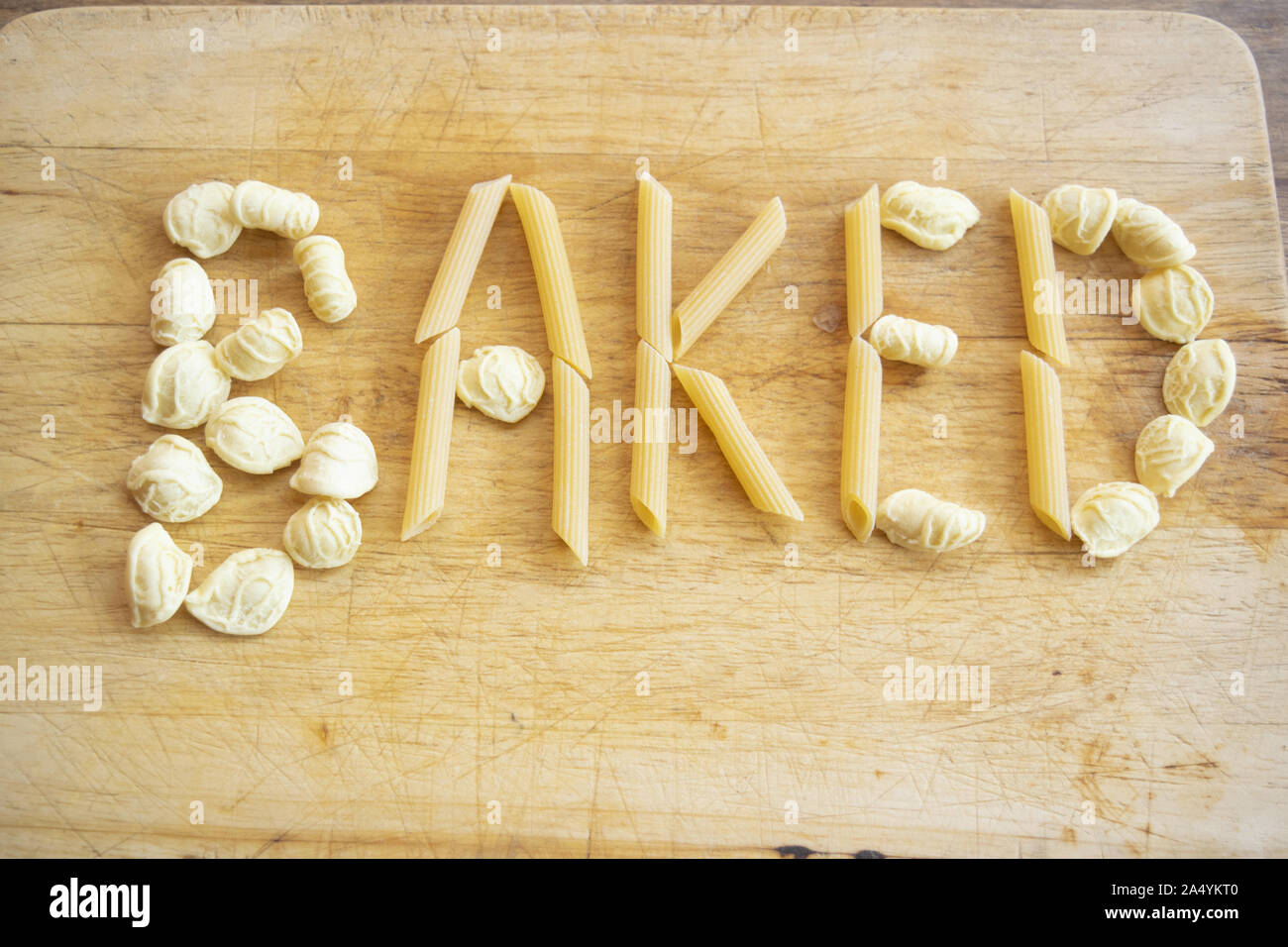 word baked written with pieces of pennette and orecchiette Stock Photo ...