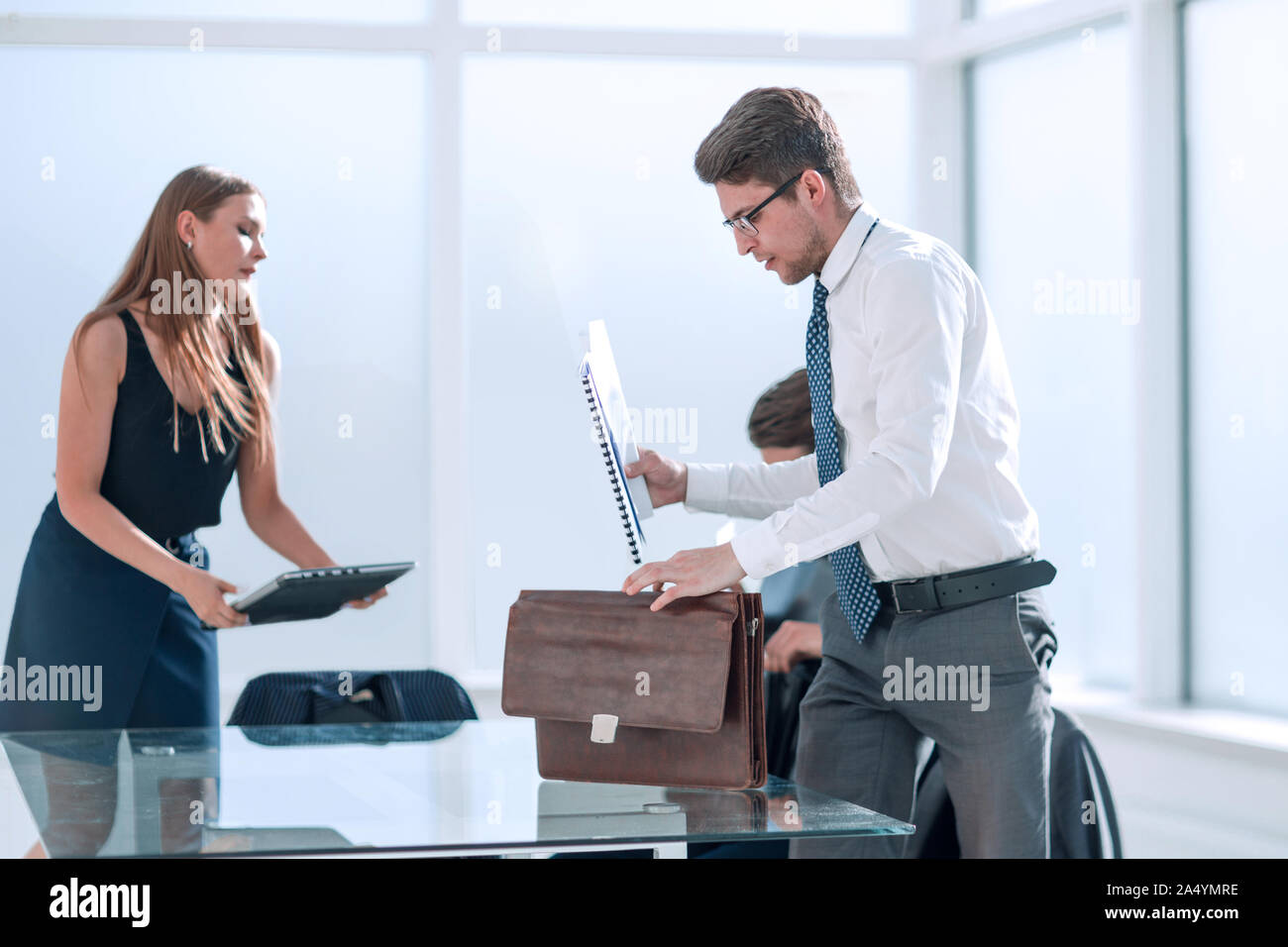 young employees completing their work in the office Stock Photo - Alamy