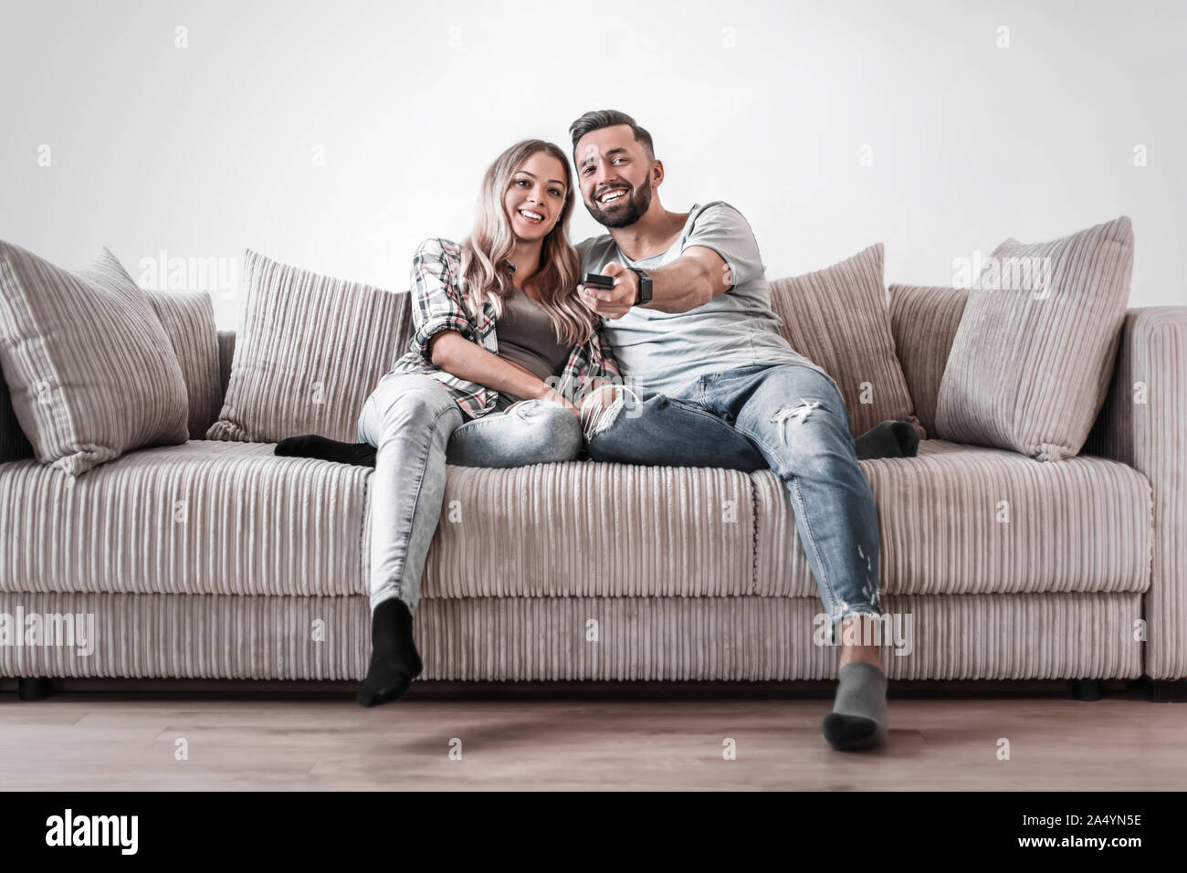 Young couple enjoying themselves on the sofa in the living room Stock ...
