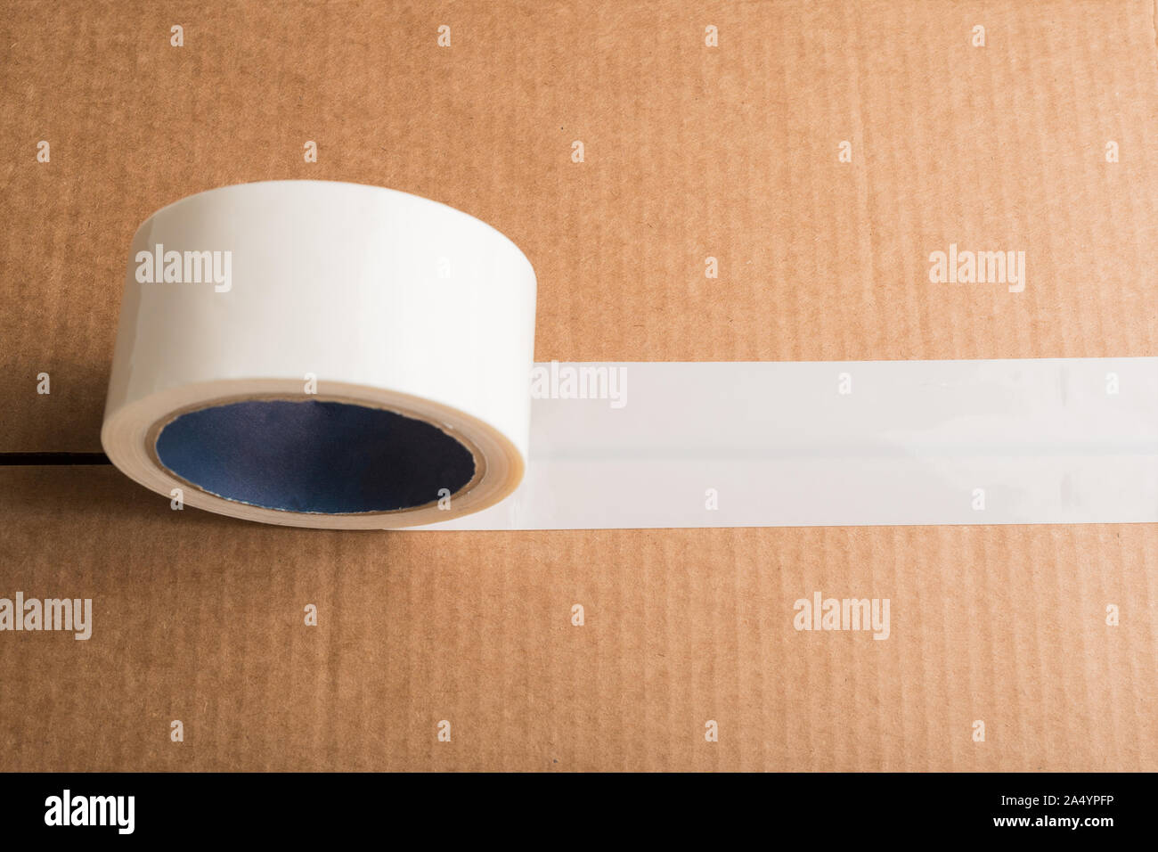 Cardboard box with white adhesive tape with copyspace Stock Photo - Alamy