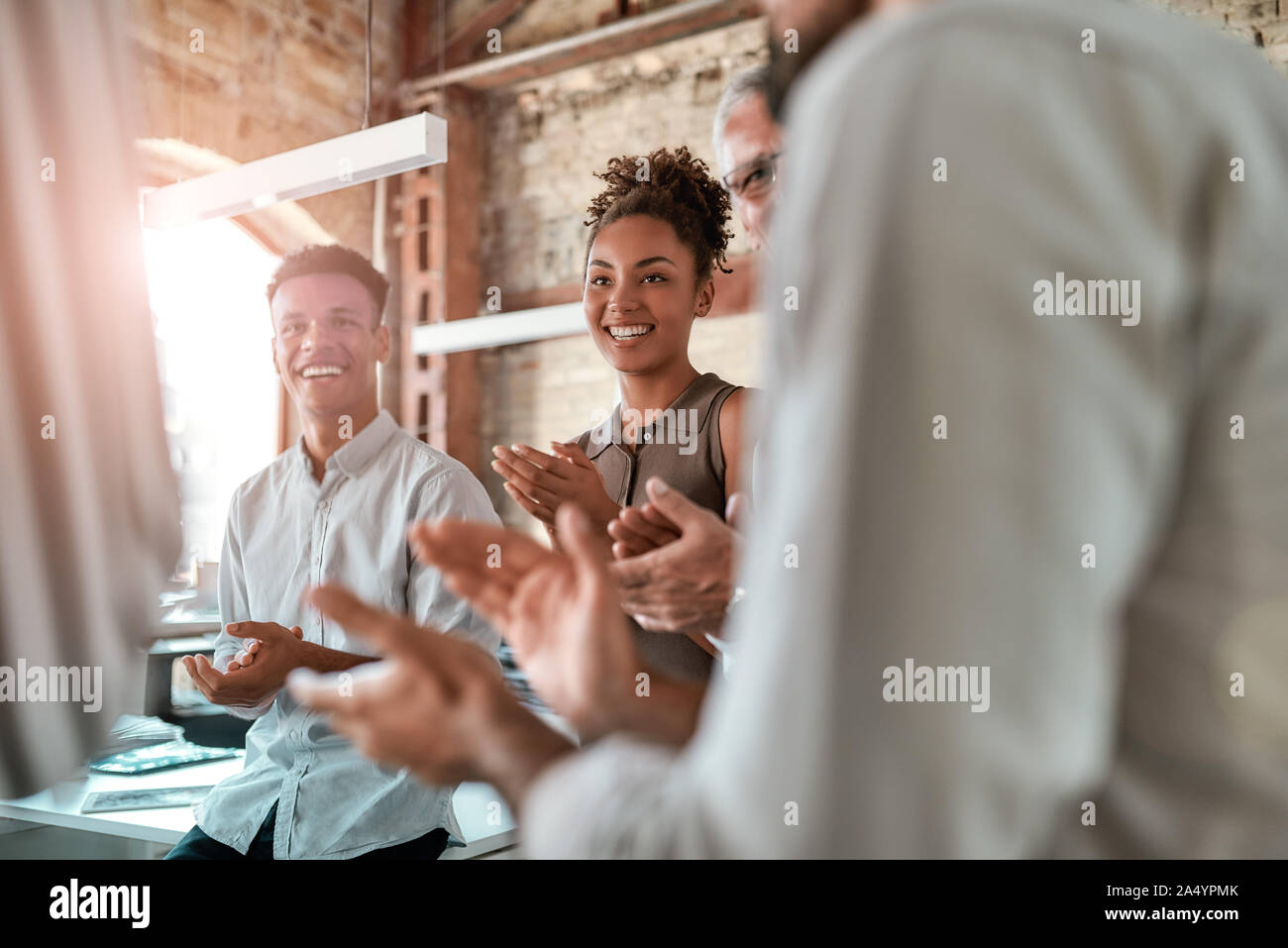 Great work! Two african colleagues clapping their hands and smiling ...