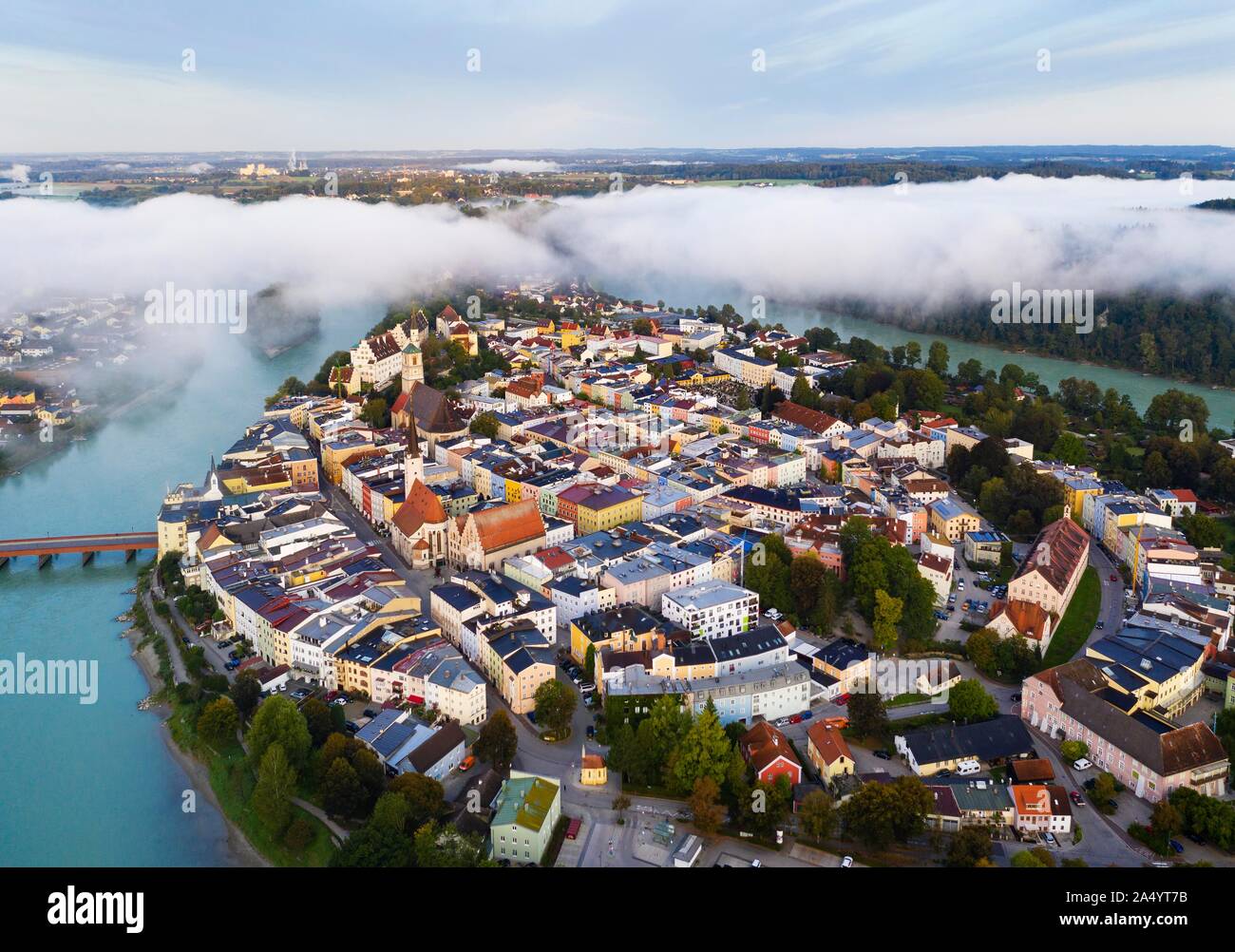 Old town in river bend of the Inn at dawn and fog, moated castle am Inn ...