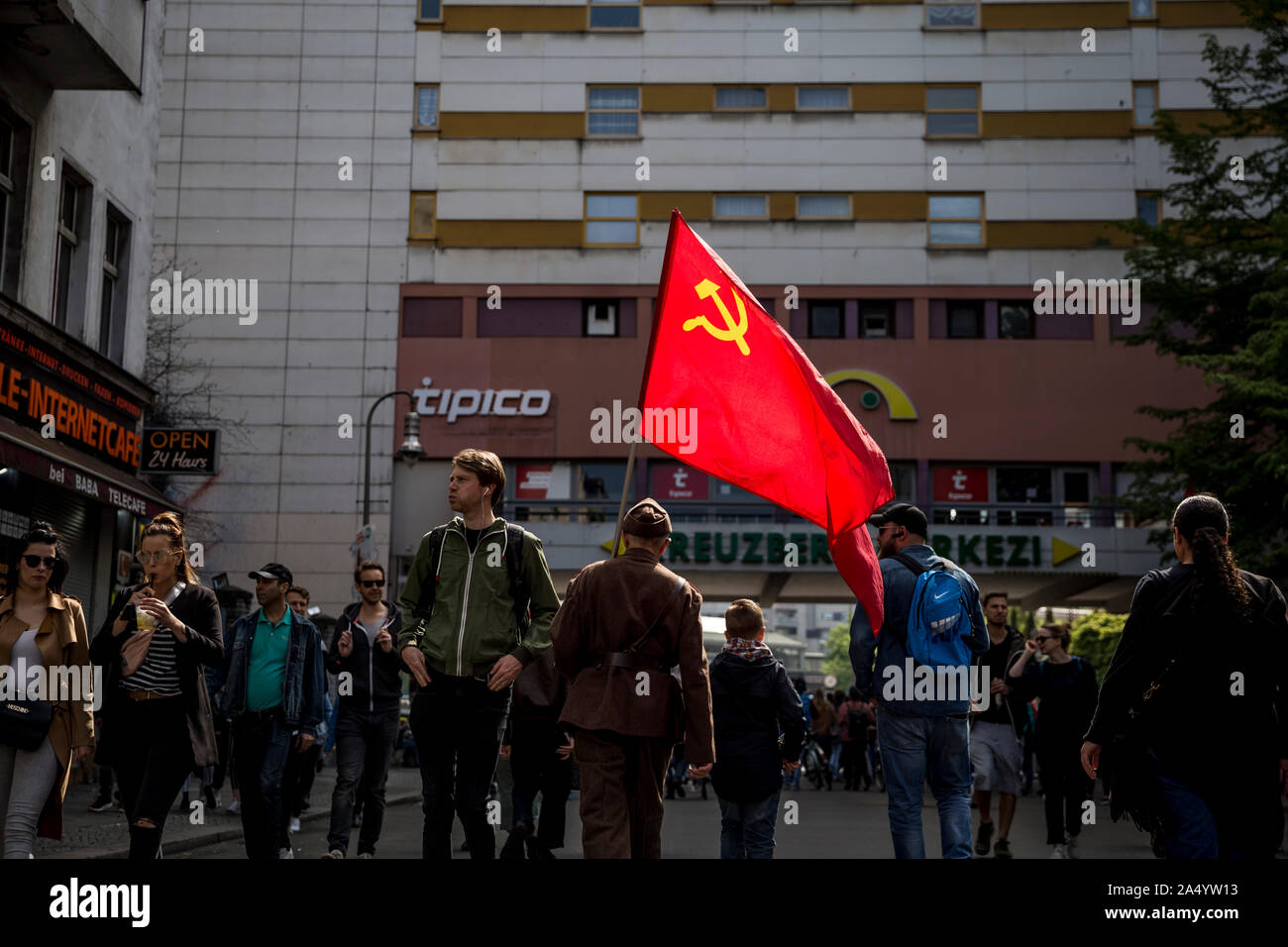 An elderly man in military uniform carries a communist flag on May Day ... An elderly man in military uniform carries a communist flag on May Day ...