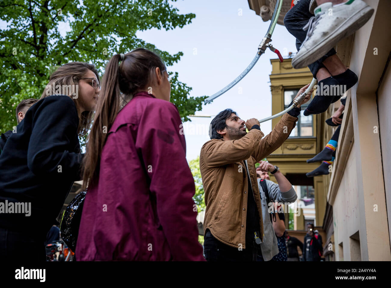 A man has a beer funnel on May Day 2019 in Berlin, Germany Stock Photo ...