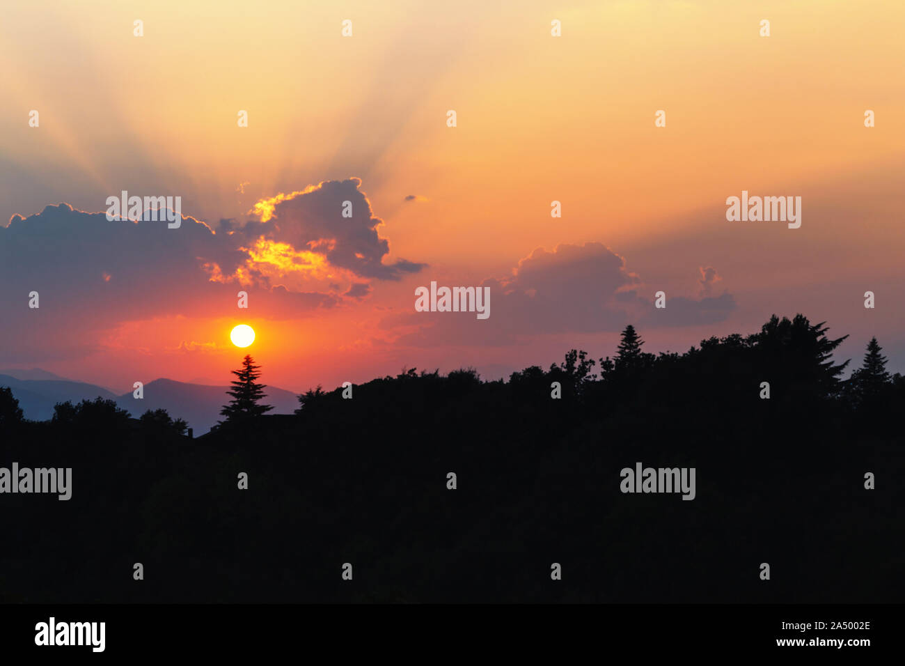 Landscape at twilight, dramatic sunset, cloudy weather with sunlight ...
