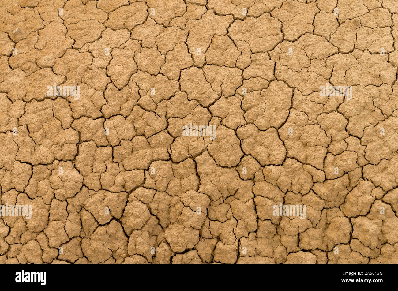 Clay sandy earth parched and cracked Stock Photo - Alamy