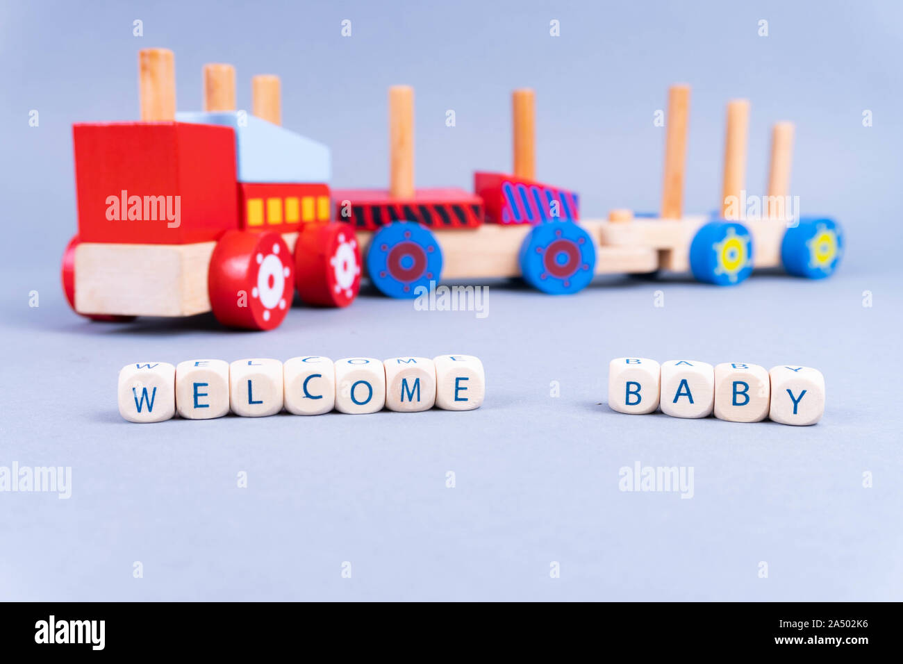 Letters saying "Welcome Baby" in the front, a colorful toy train in the ...